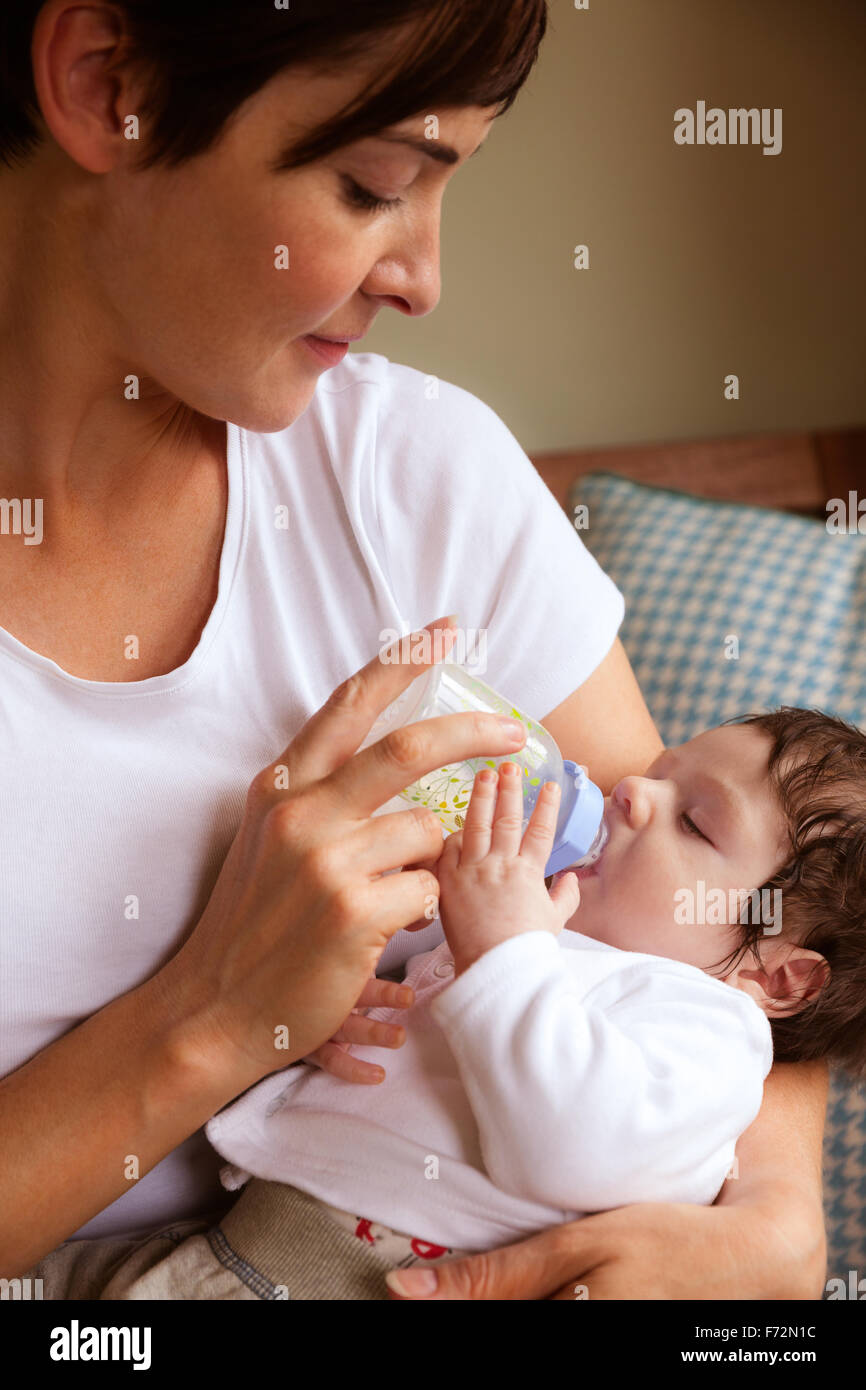 Baby boy being bottle fed hi-res stock photography and images - Alamy