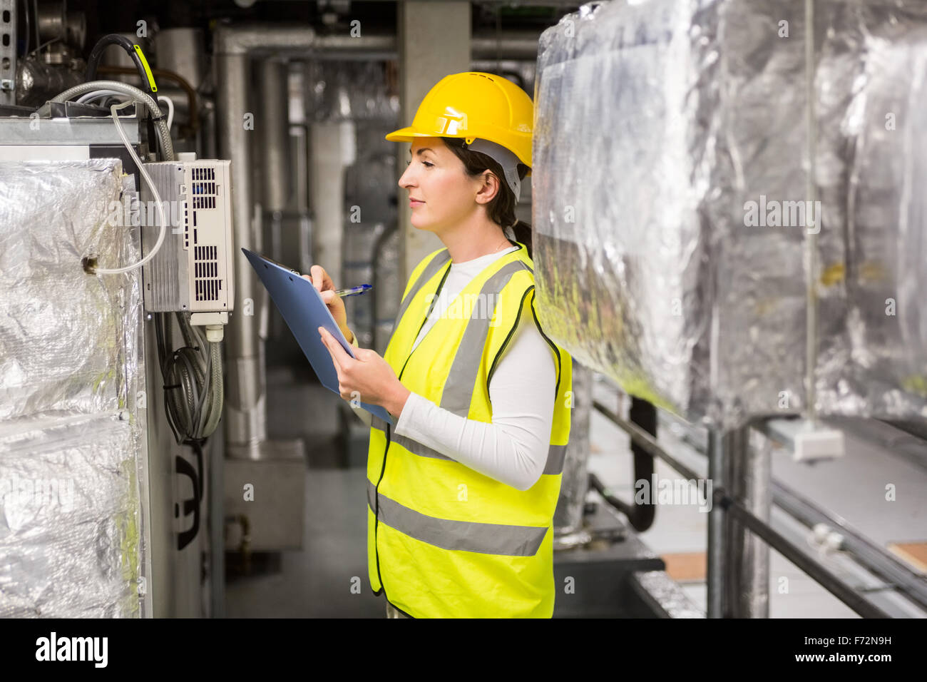 Engineer checking the temperature pipes Stock Photo - Alamy