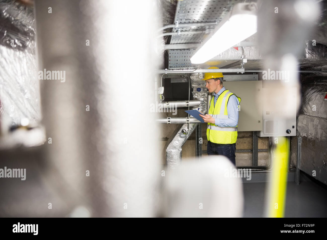 Engineer checking the temperature pipes Stock Photo - Alamy