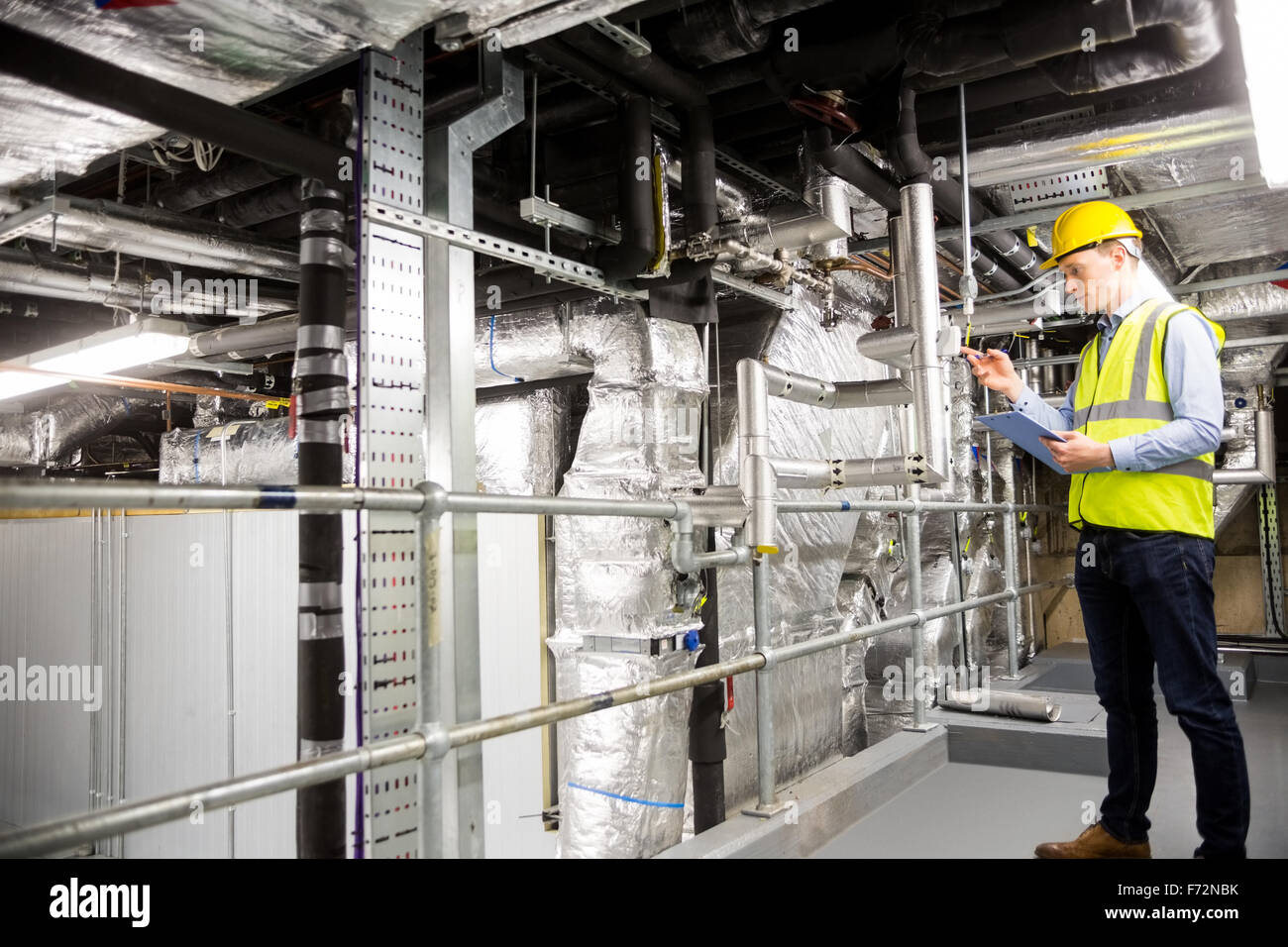 Engineer checking the temperature pipes Stock Photo - Alamy