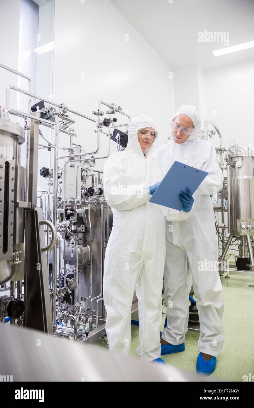 Scientists working with large vat Stock Photo - Alamy
