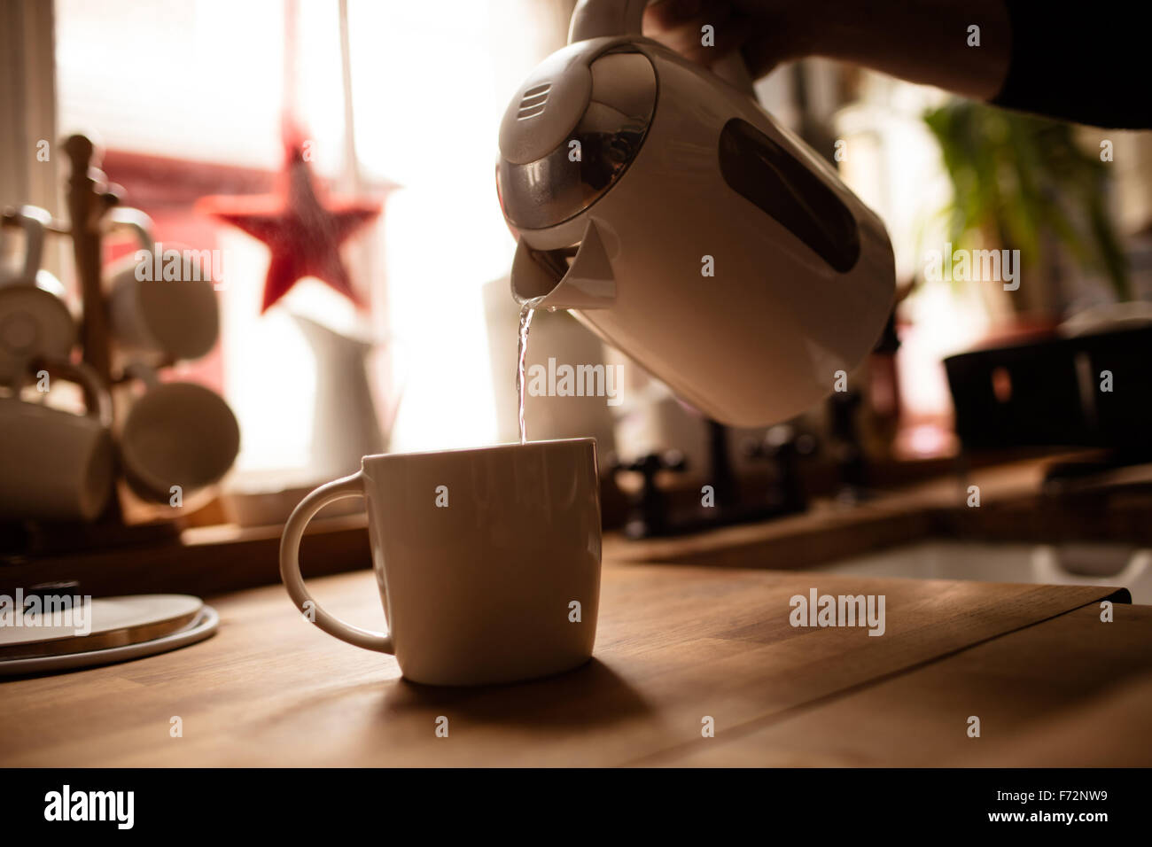 Young man making tea in hi-res stock photography and images - Alamy