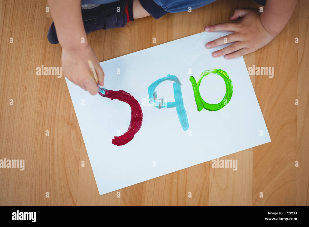 Boy painting an abc on some paper Stock Photo - Alamy