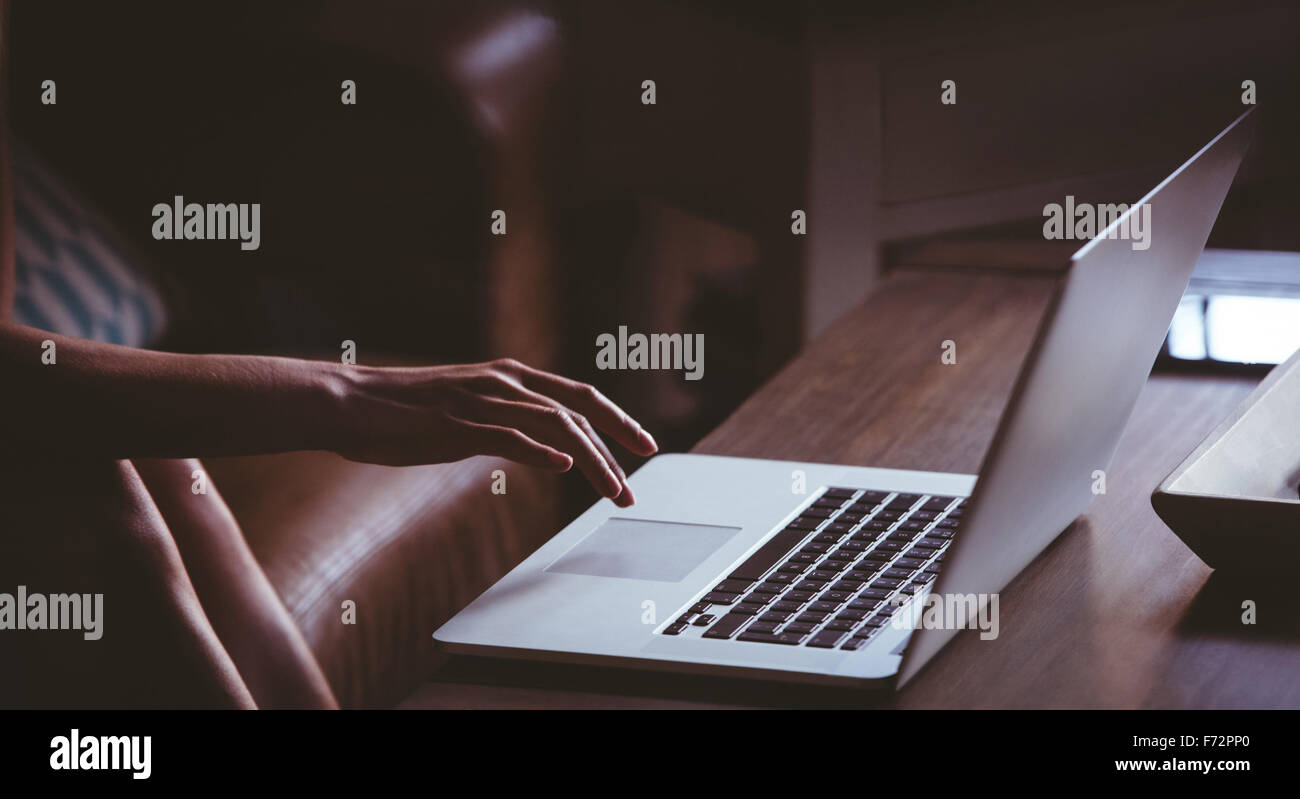 Cropped image of woman using laptop Stock Photo - Alamy