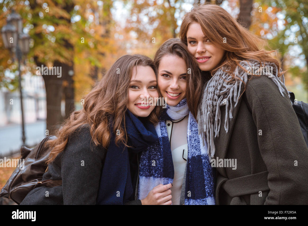 Three women friends hug autumn hi-res stock photography and images - Alamy