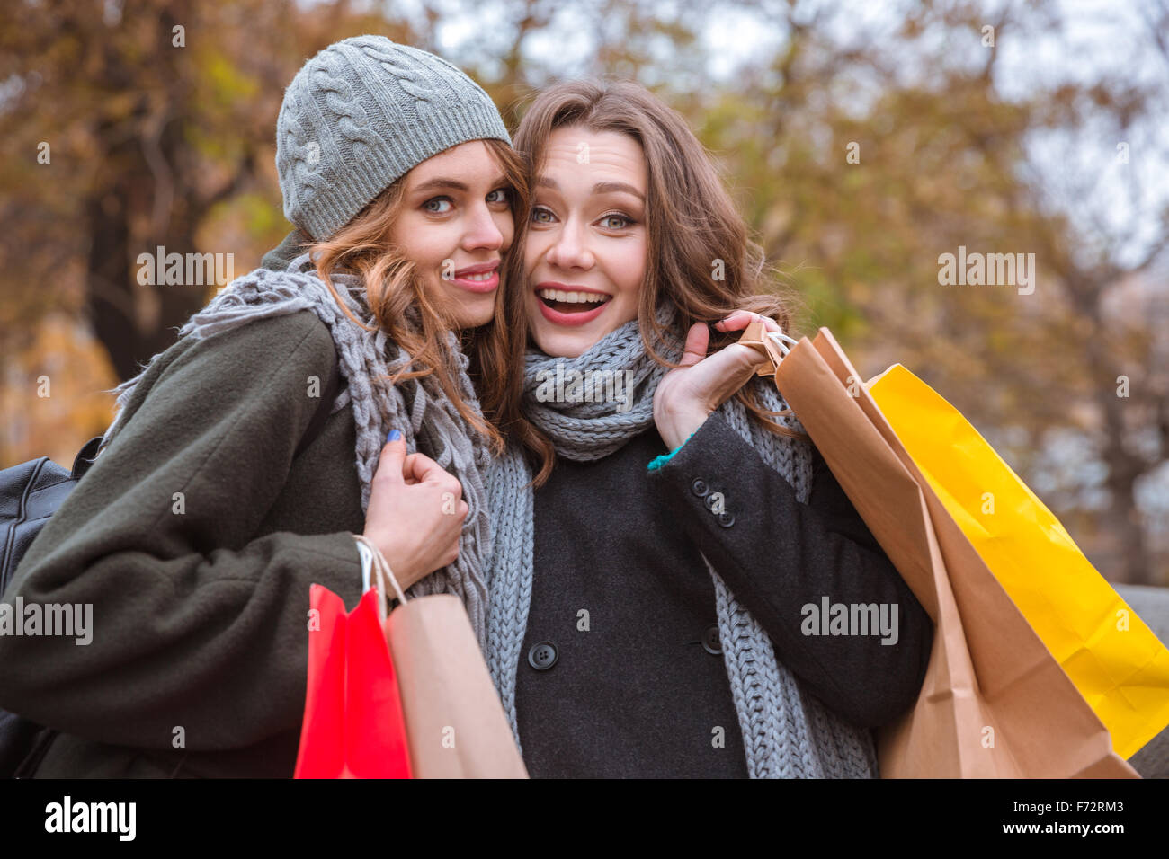 Portrait of a beautiful two women holding shopping bags outdoors Stock ...