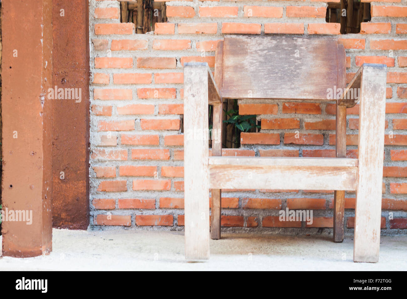 Wooden chair with red bricks wall, stock photo Stock Photo - Alamy