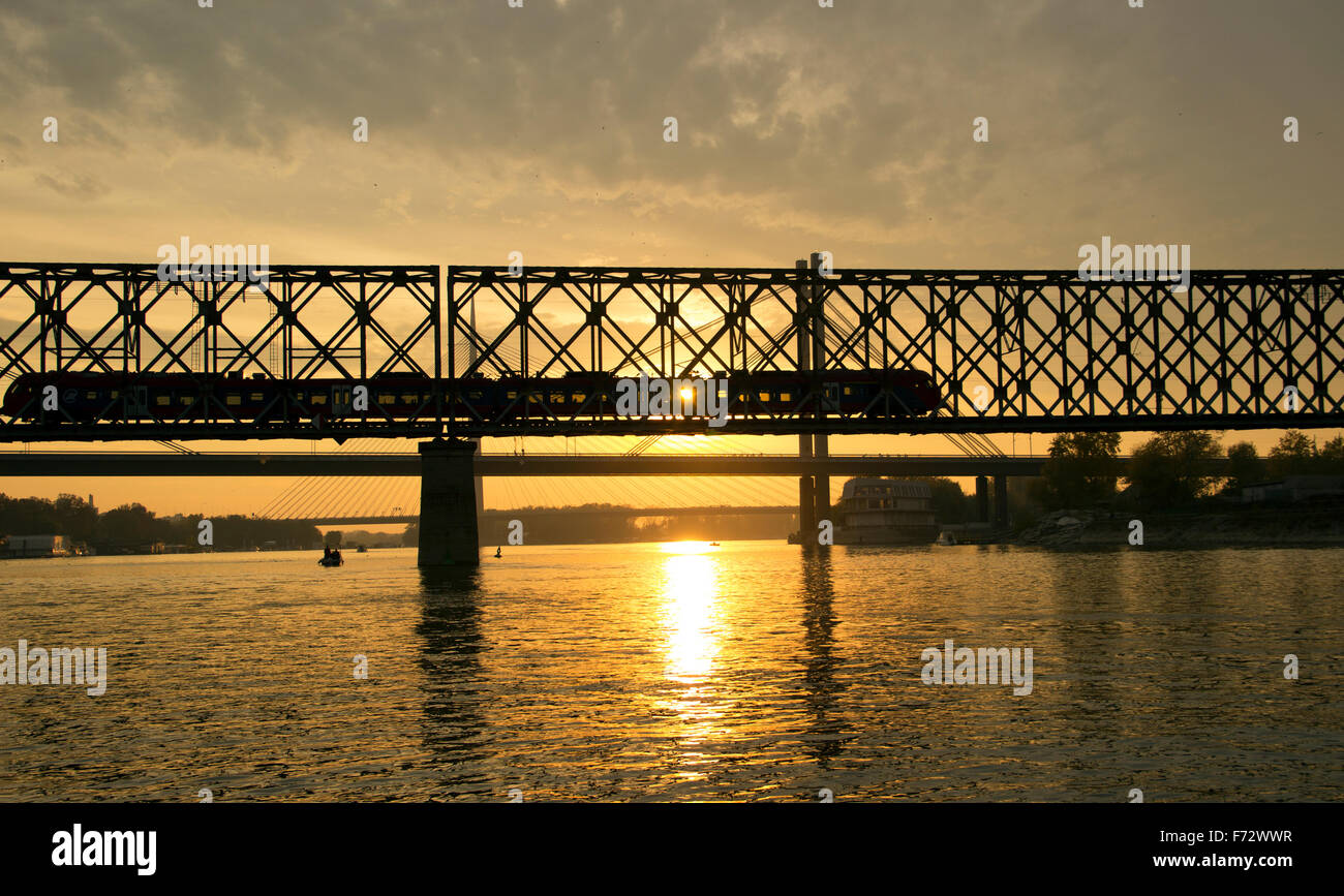 Belgrade, Serbia - Train crosses the bridge over the Sava river at dusk ...