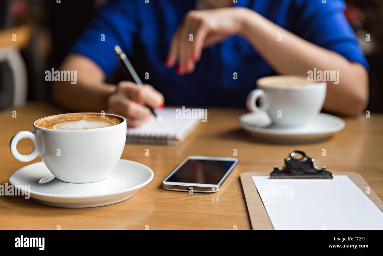 coffee break at the restaurant, taking notes Stock Photo - Alamy