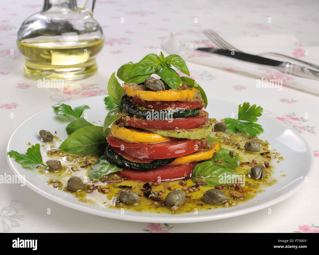 Appetizer of zucchini with tomato, pesto and capers Stock Photo - Alamy