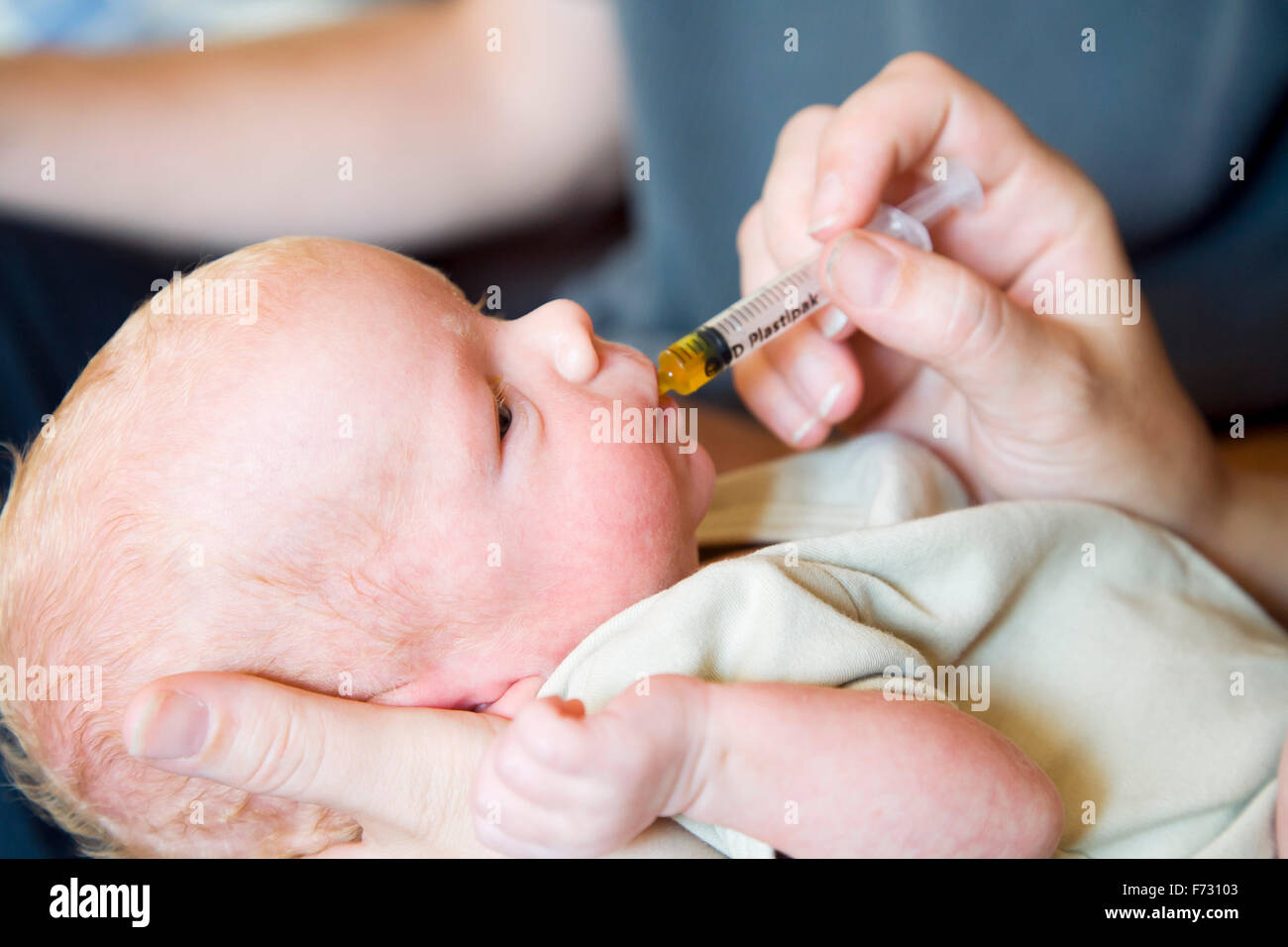 Giving infant medication Stock Photo - Alamy