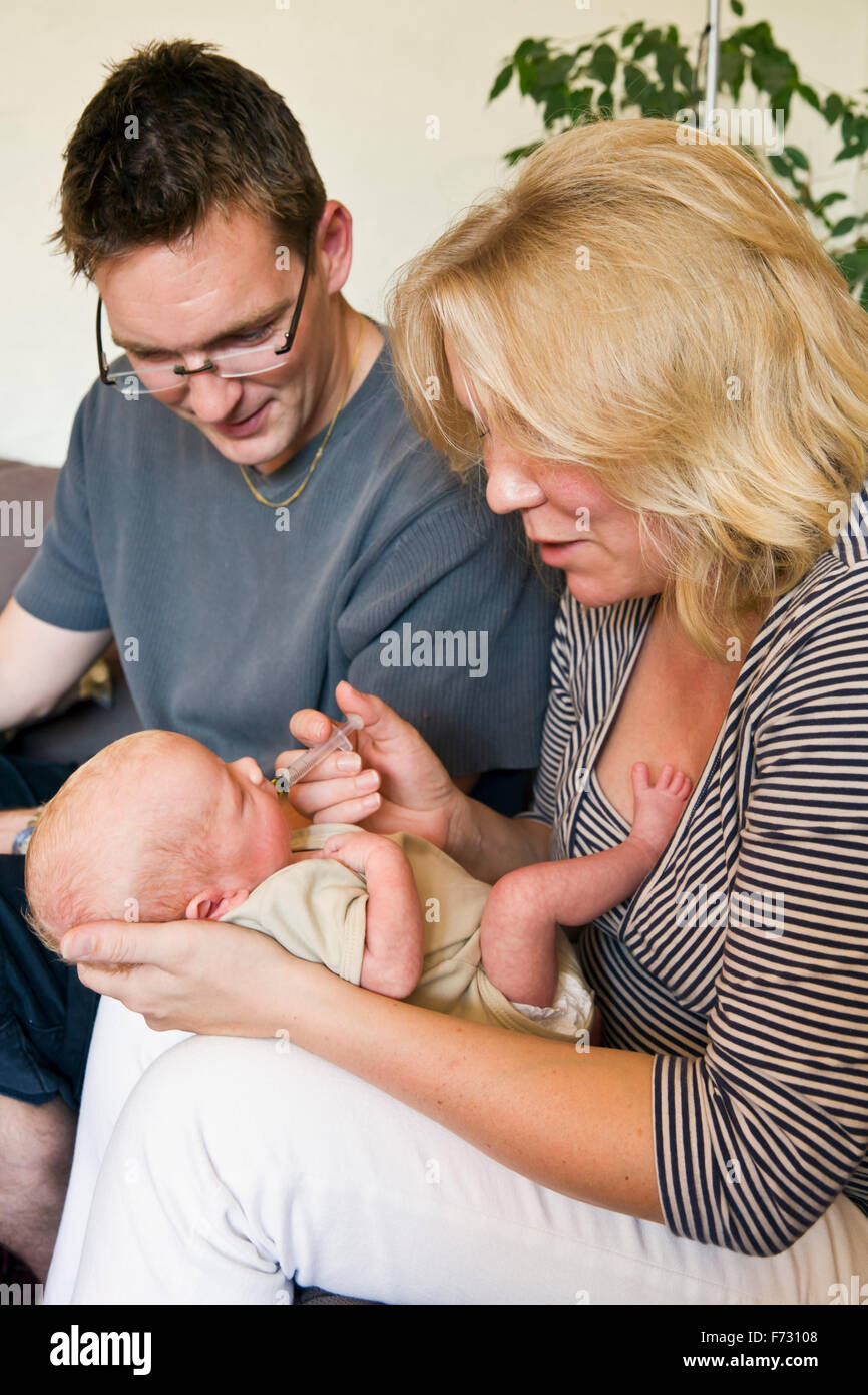 Giving infant medication Stock Photo - Alamy