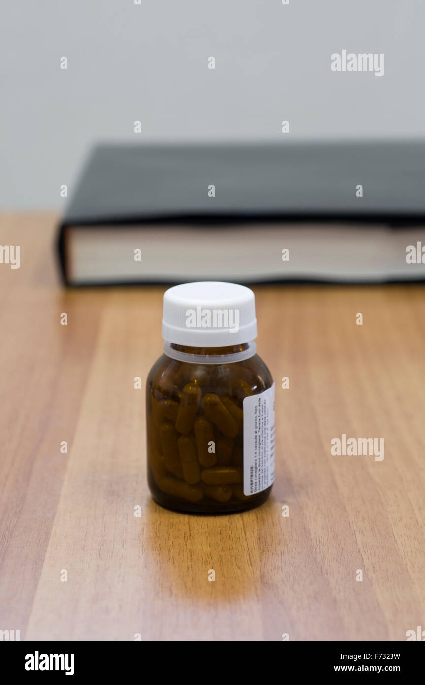bottle of vitamin capsules on desk Stock Photo - Alamy