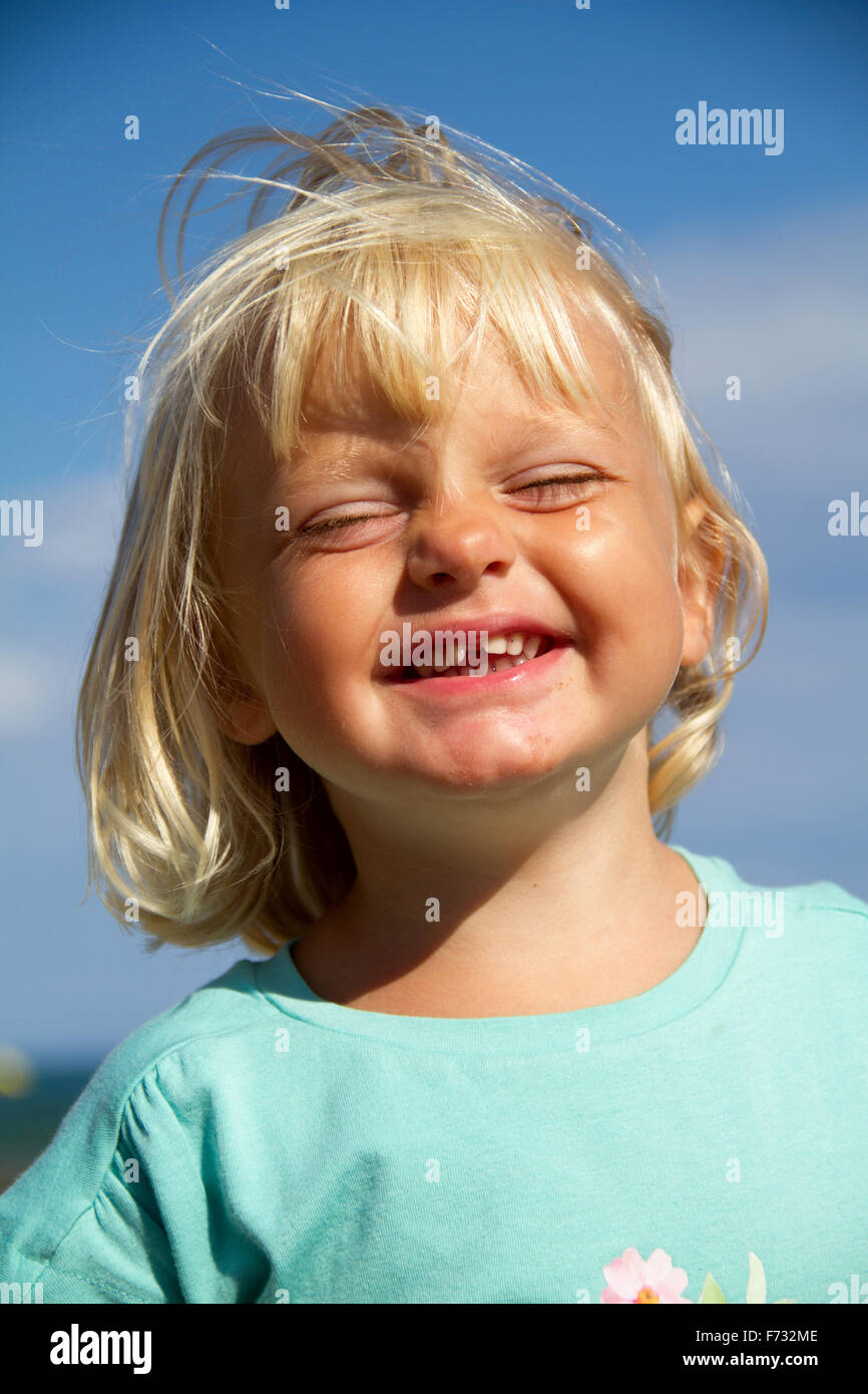 portrait of happy child in blue sky Stock Photo - Alamy