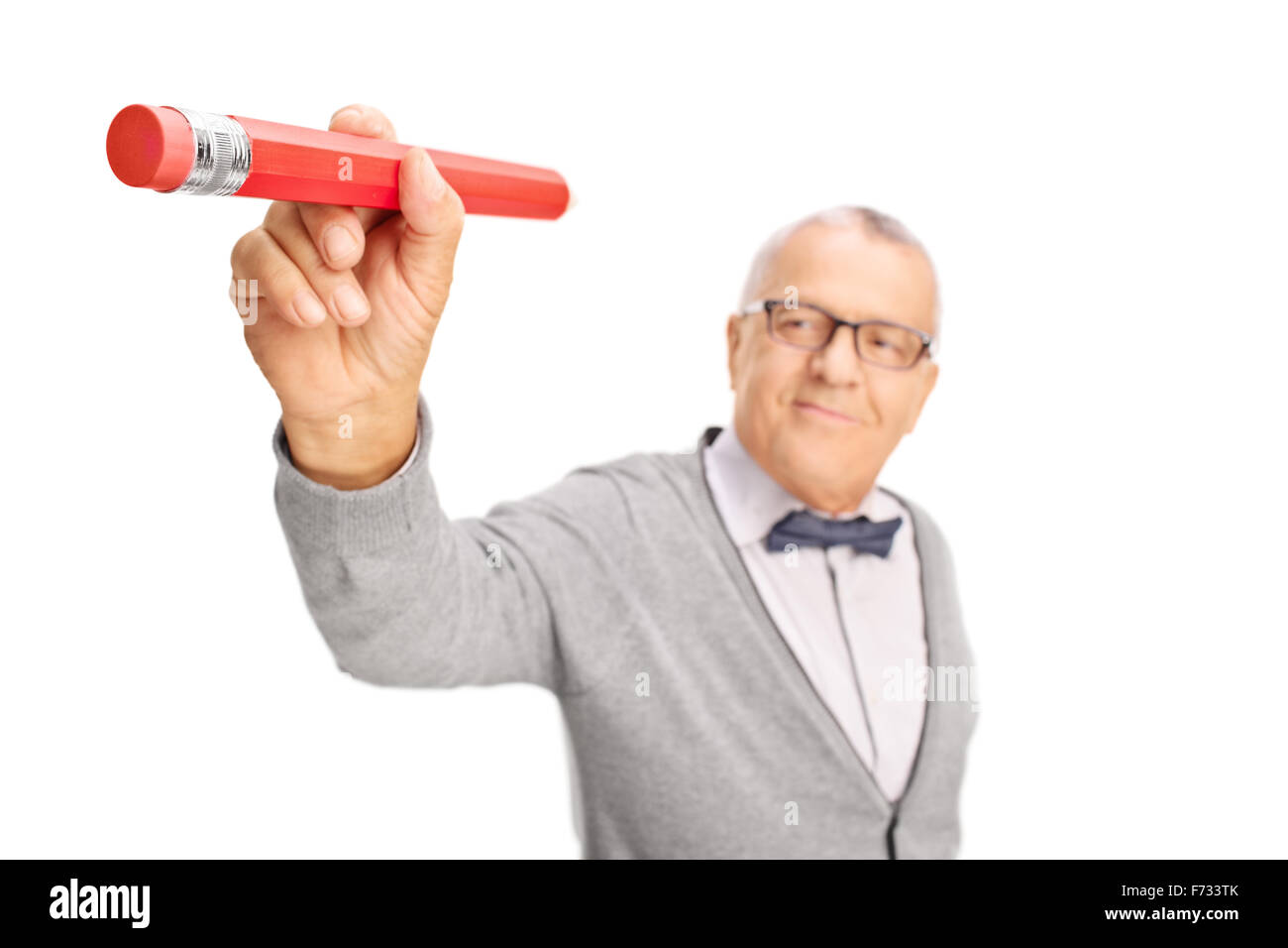 Mature teacher erasing something with the backside eraser of a pencil ...