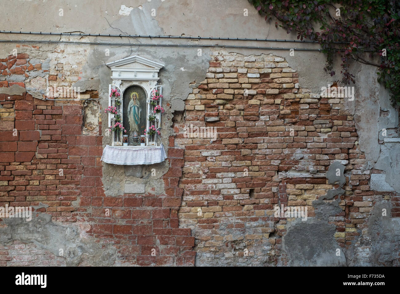 Religious shrine in brick wall, castello, Venice, Italy Stock Photo - Alamy
