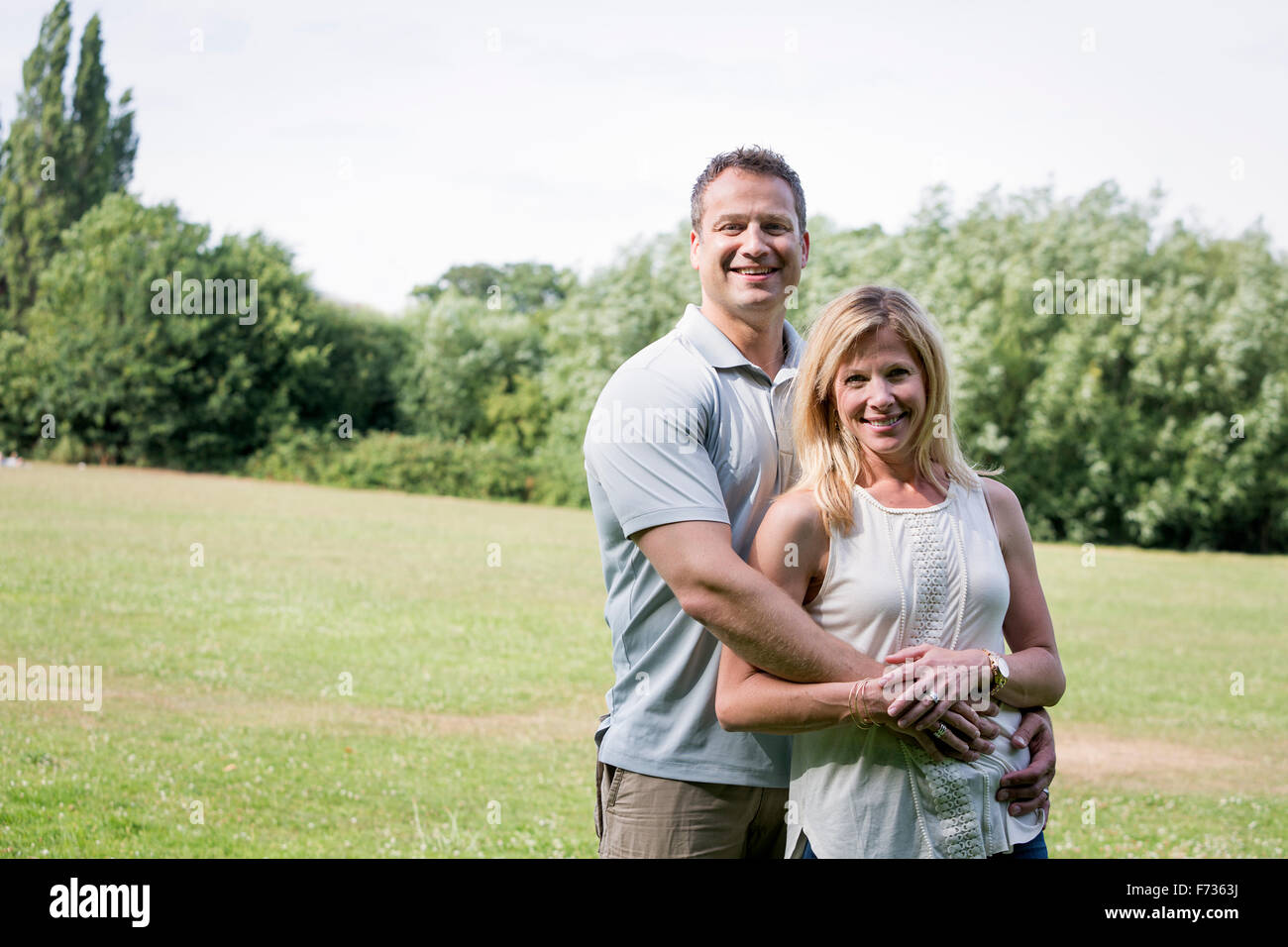 Family three embracing in hi-res stock photography and images - Alamy