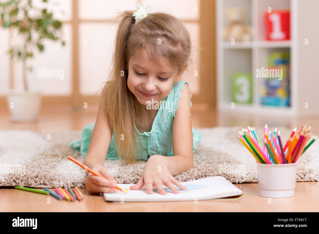 Child little girl child kid drawing at home Stock Photo - Alamy