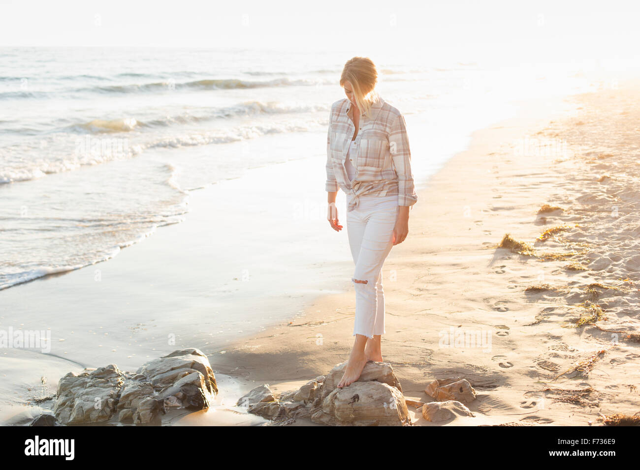 Person walking down the beach hi-res stock photography and images - Alamy