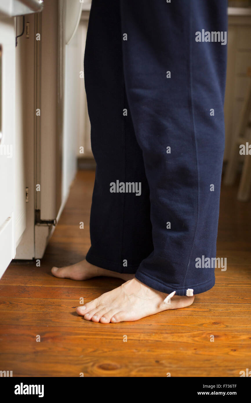 Barefoot man standing in a kitchen Stock Photo - Alamy