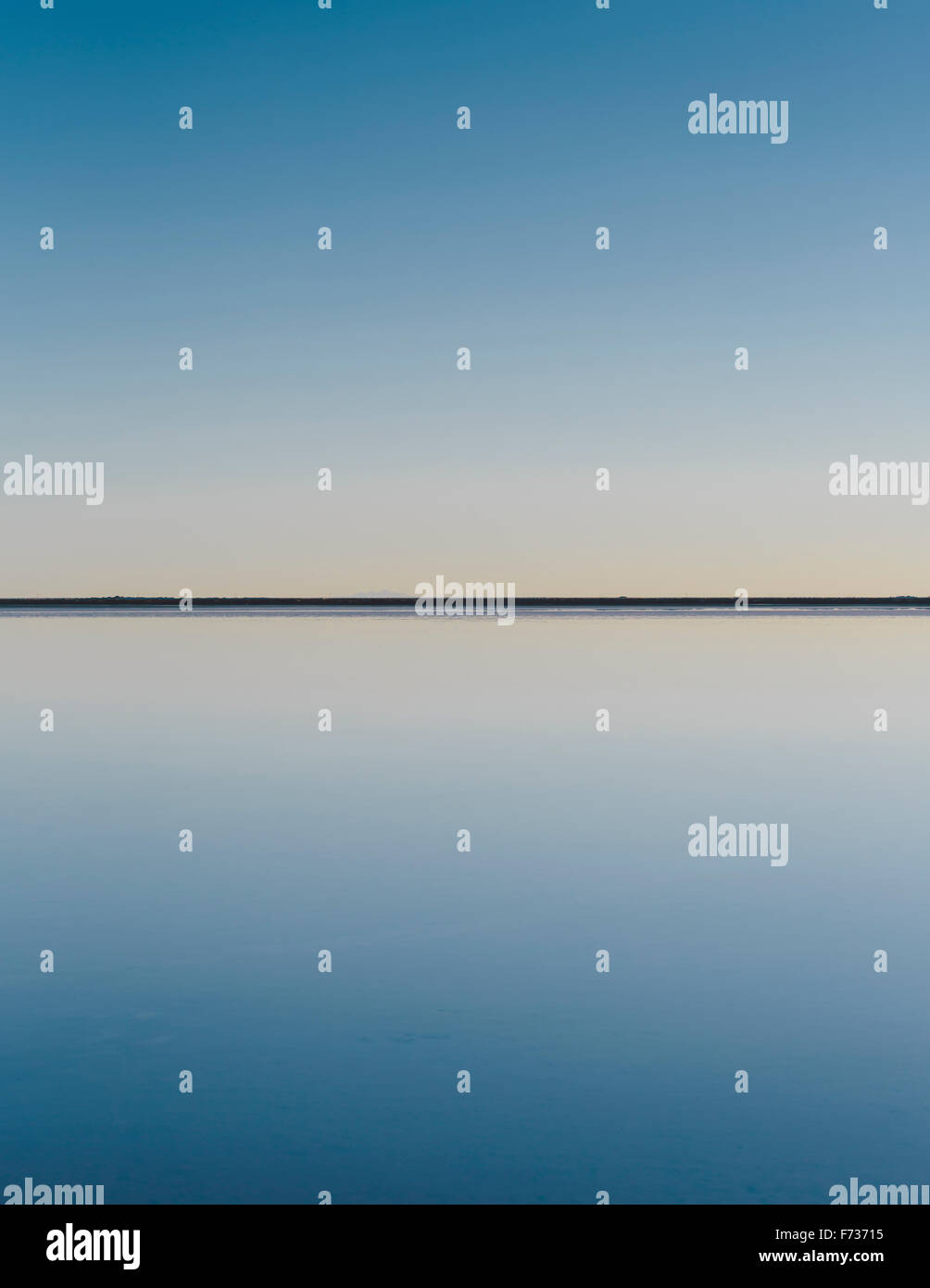 The view to the clear line of the horizon where land meets sky, across ...