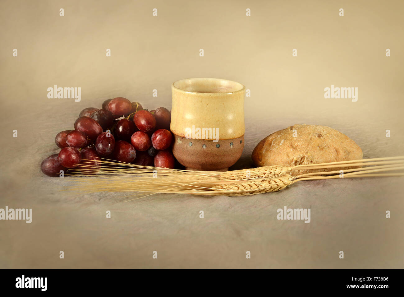 Communion table with cup of wine, grapes, bread and wheat Stock Photo ...