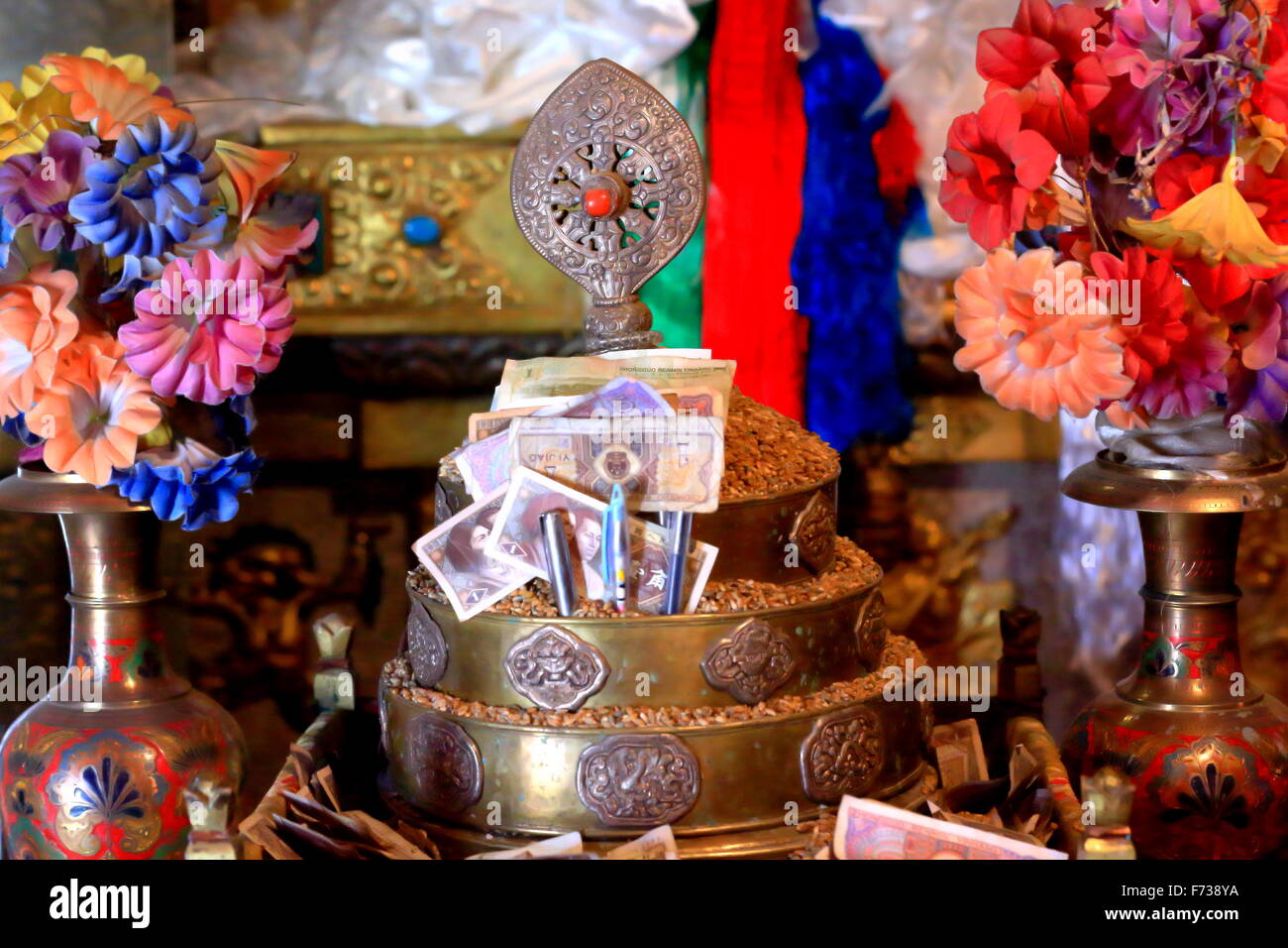 Dharmachakra topped brass mandala set-plastic flowers-metallic vases ...