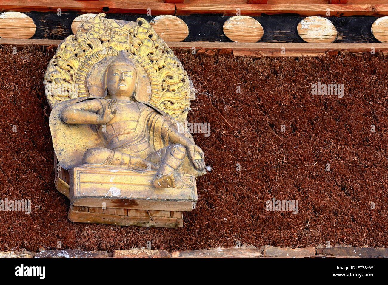 Gilded Buddha relief-wood and red heather wall-shrine on Ponpori Hill ...