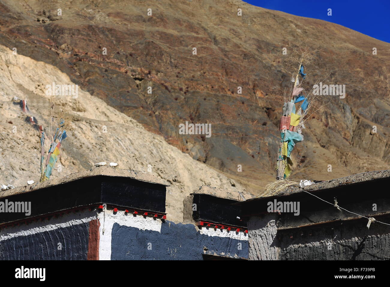 Grey walls-white red stripes-buddhist prayer flags over town home ...