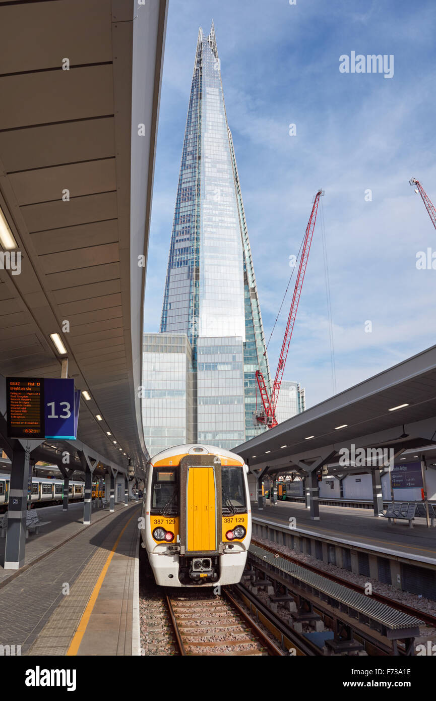 Train at London Bridge rail station with Shard skyscraper in the ...