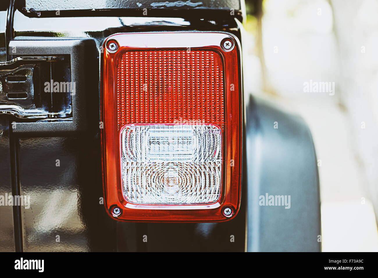 Close-up view of black sports car rear light Stock Photo - Alamy