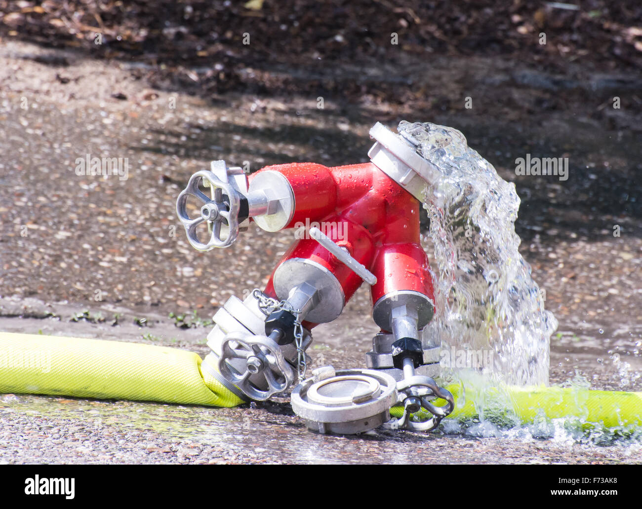 Water splashing out of a valve for a firehose Stock Photo - Alamy