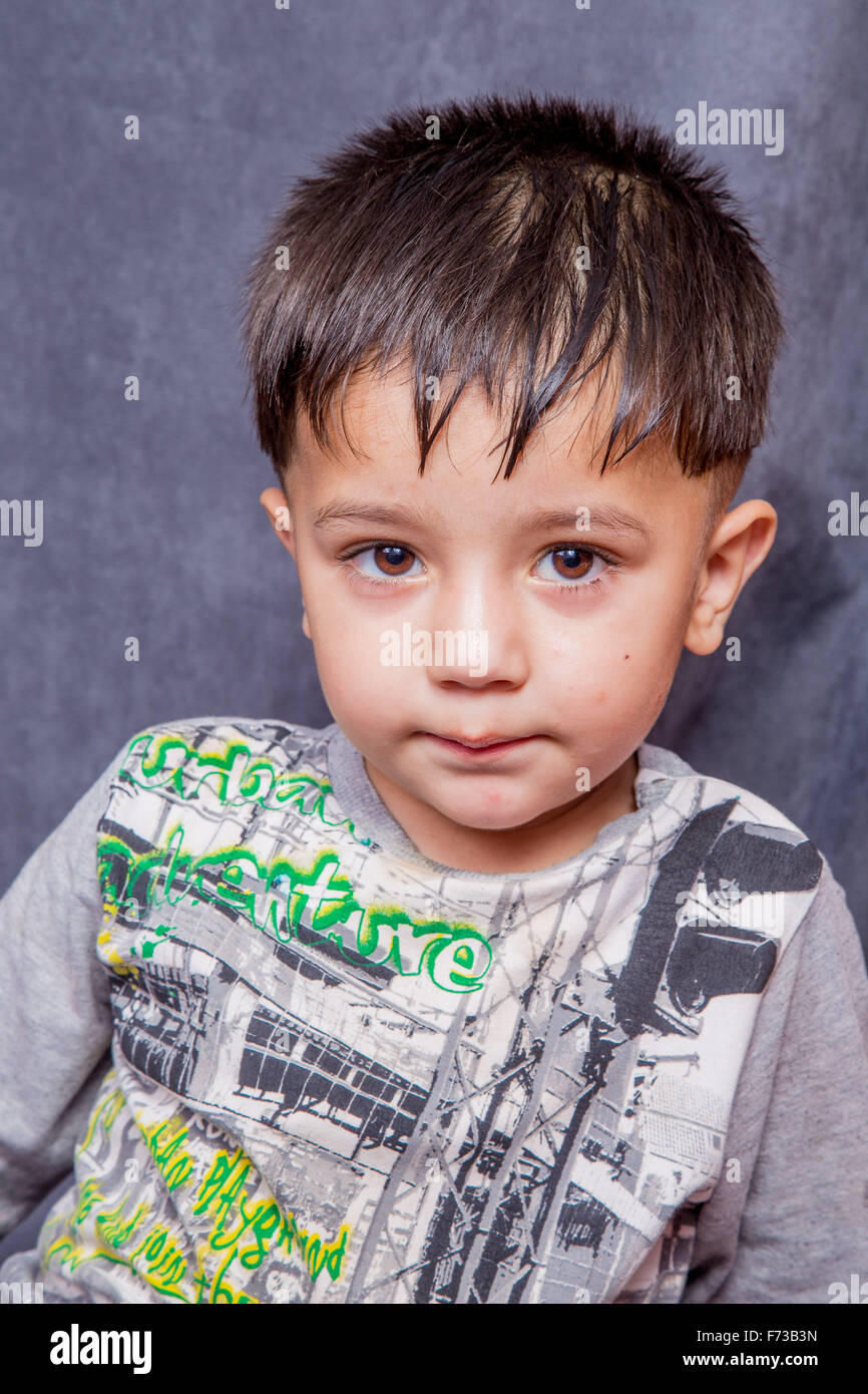 Portrait of Small Boy urban background with modern haircut Stock Photo ...