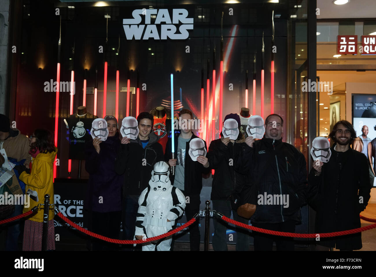 London, England, UK, 24th Nov 2015 : A group of people queue with a ...