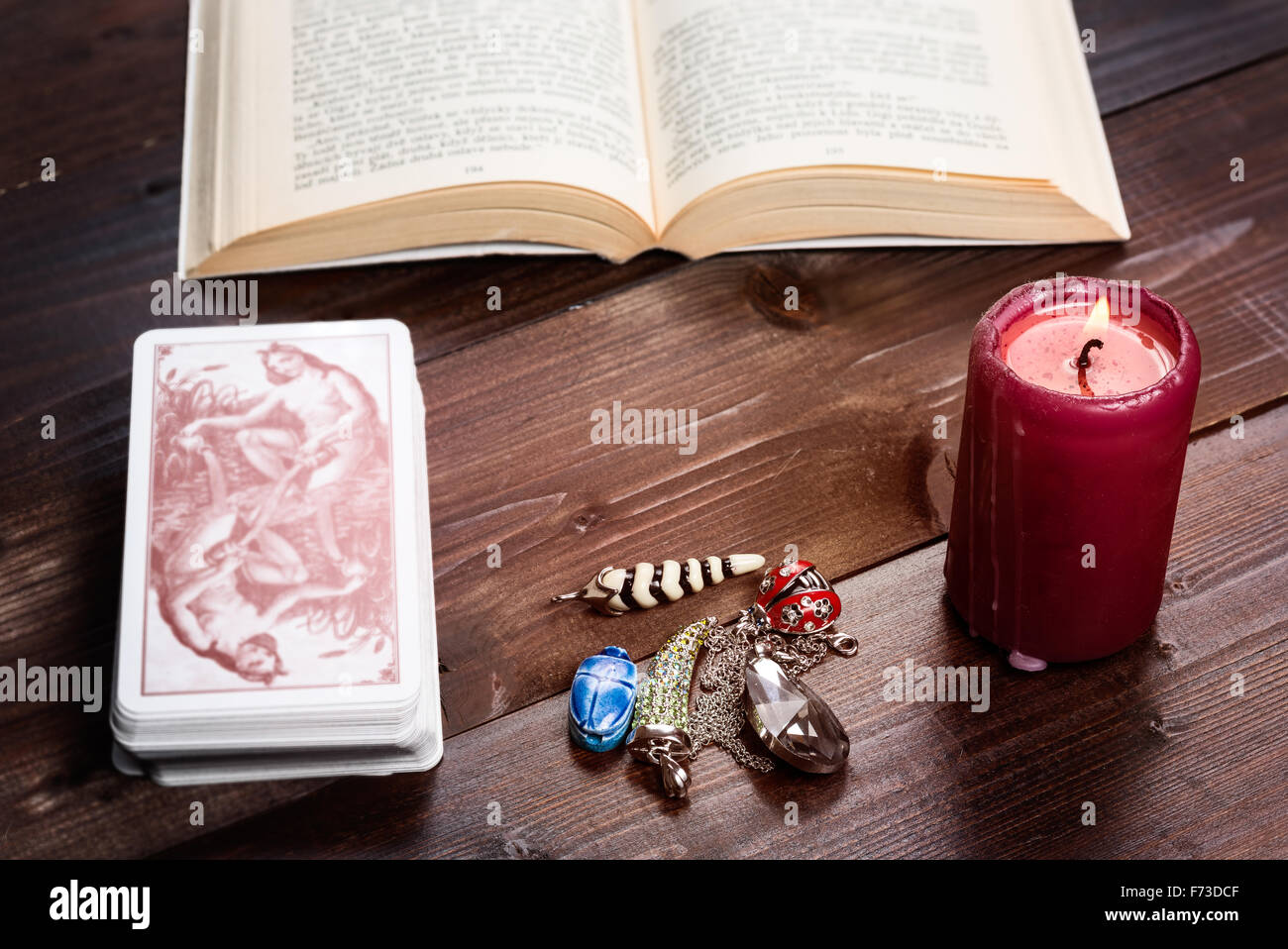 Composition of esoteric objects,candle,cards and book used for healing ...