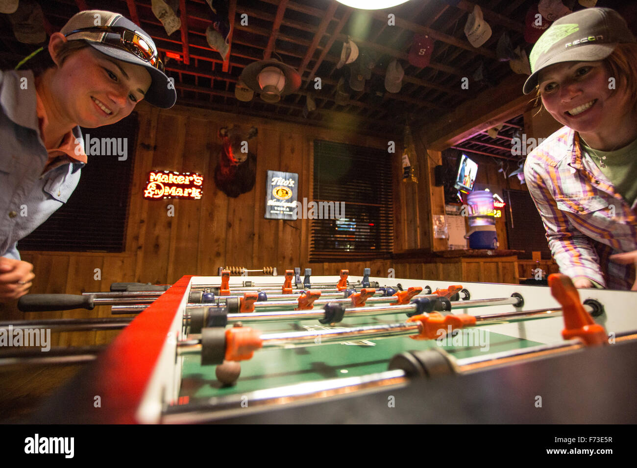 Two young women play foosball in a Montana bar Stock Photo - Alamy