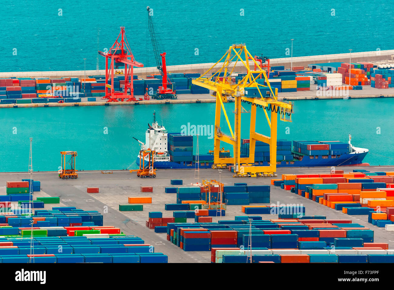 Loading containers on a sea cargo ship, Barcelona Stock Photo - Alamy