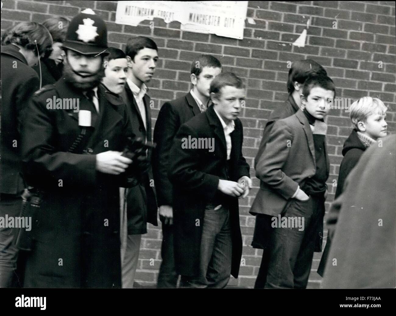 1968 - A Policeman Keeps a close watch as some skinheads line up for ...