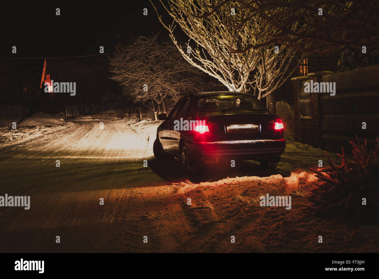 Snowy street and car light Stock Photo - Alamy