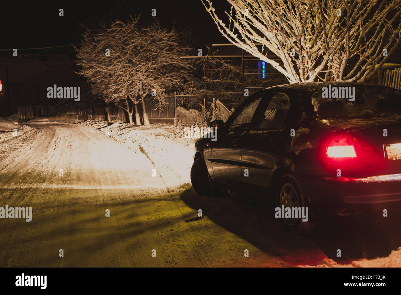 Snowy street and car light Stock Photo - Alamy