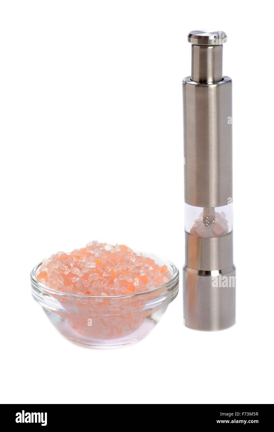 Himalayan pink salt in a glass bowl next chopper salt isolated on white ...