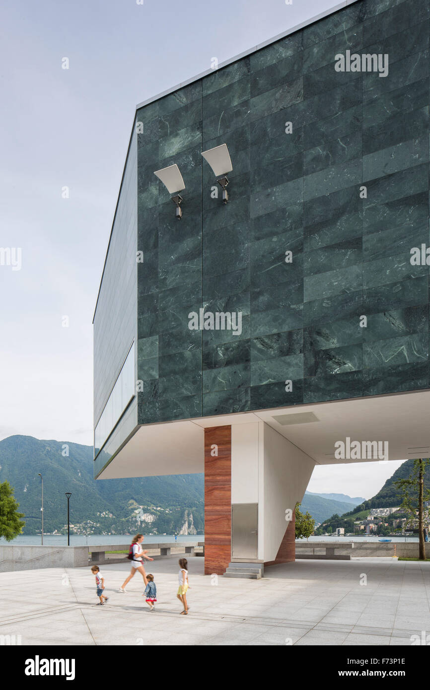 Partial view of stone clad exterior facade raised on columns. LAC ...