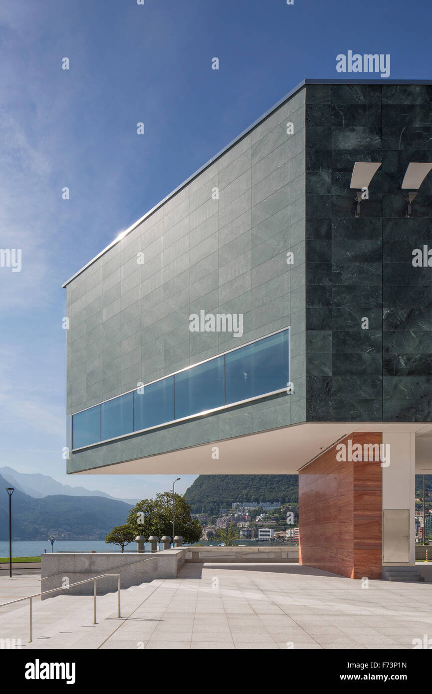 Partial view of stone clad exterior facade raised on columns. LAC ...