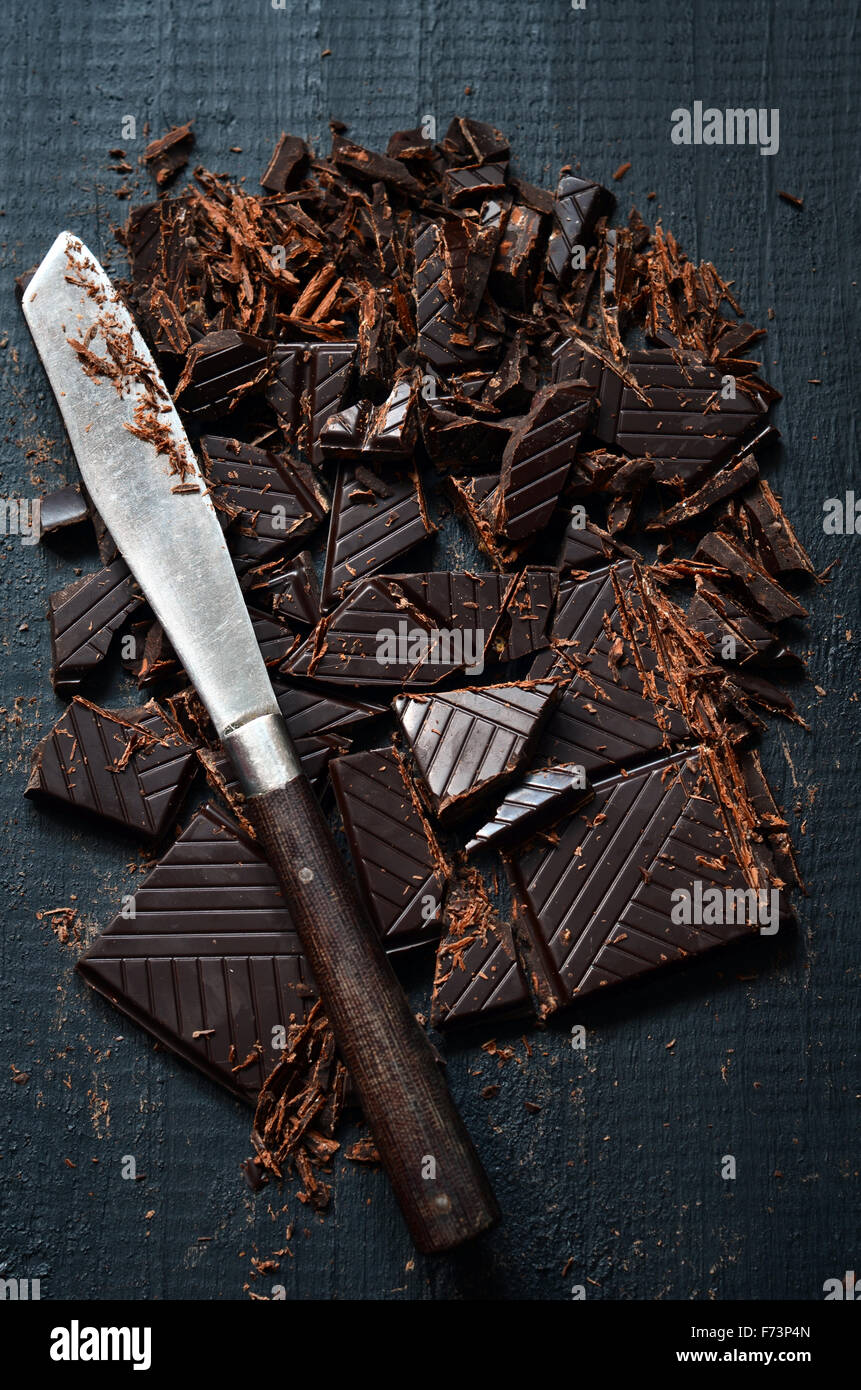 Shredded Dark Chocolate for Cooking on dark wooden background Stock ...