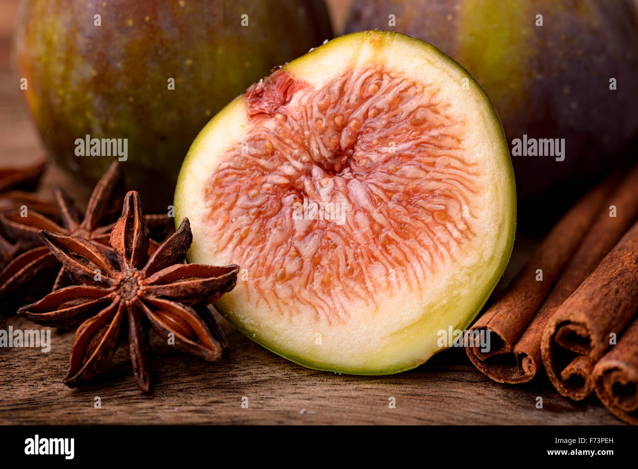 slice of fig with star anise and cinnamon on wood Stock Photo - Alamy