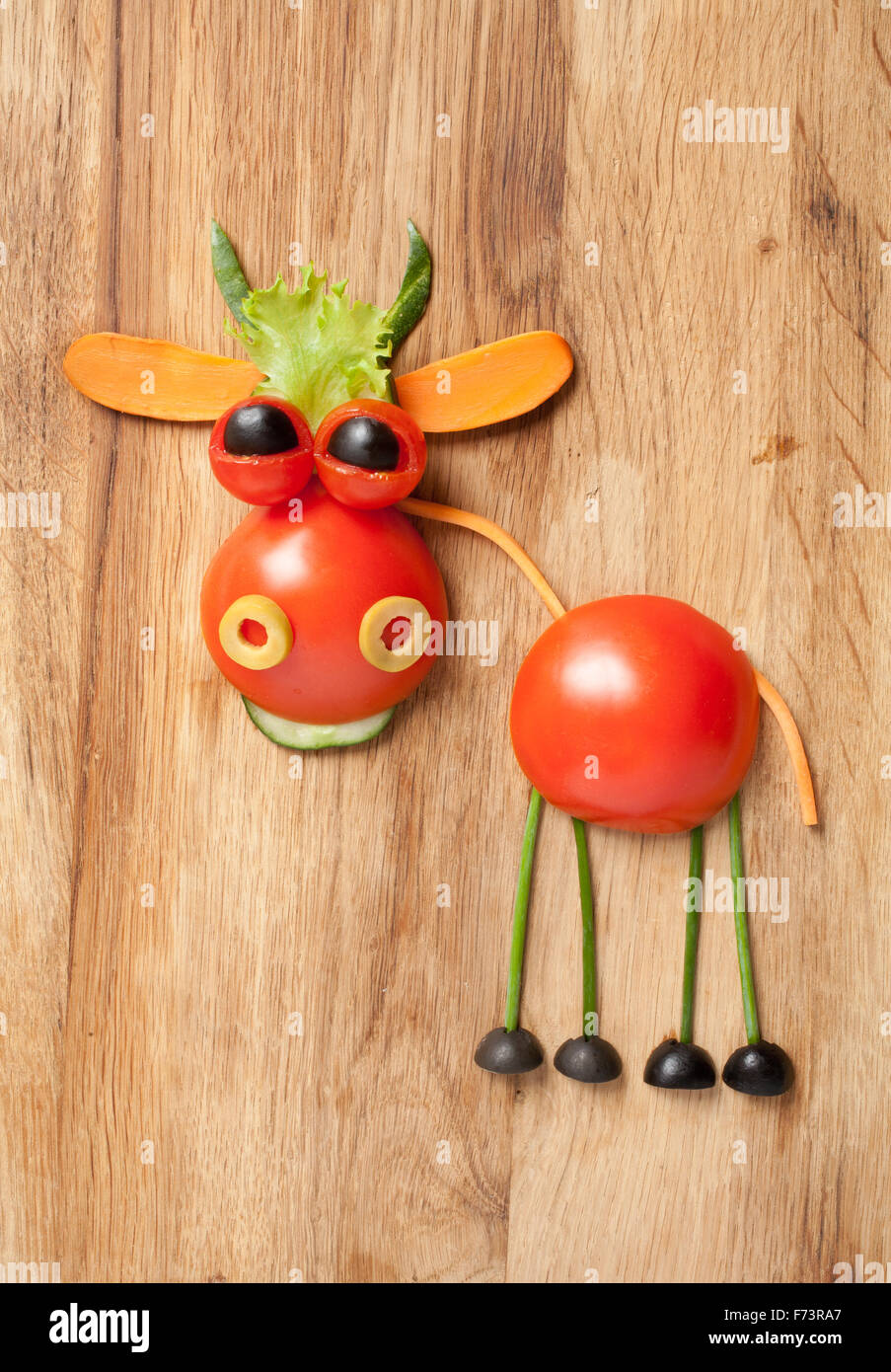 Bull made of fresh vegetables on wooden background Stock Photo - Alamy