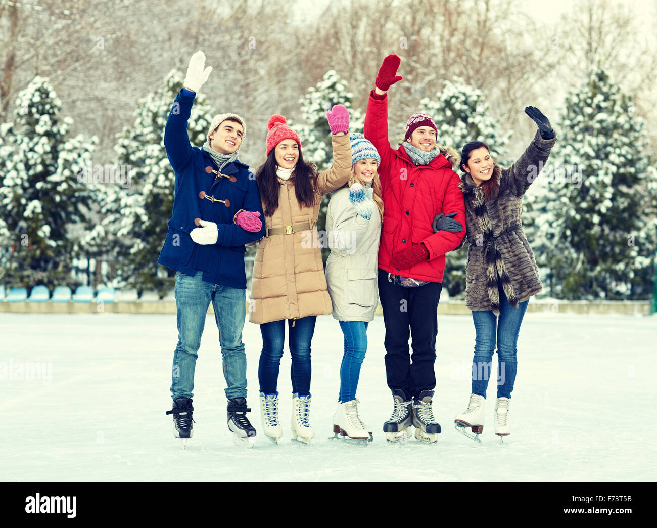 happy friends ice skating on rink outdoors Stock Photo - Alamy