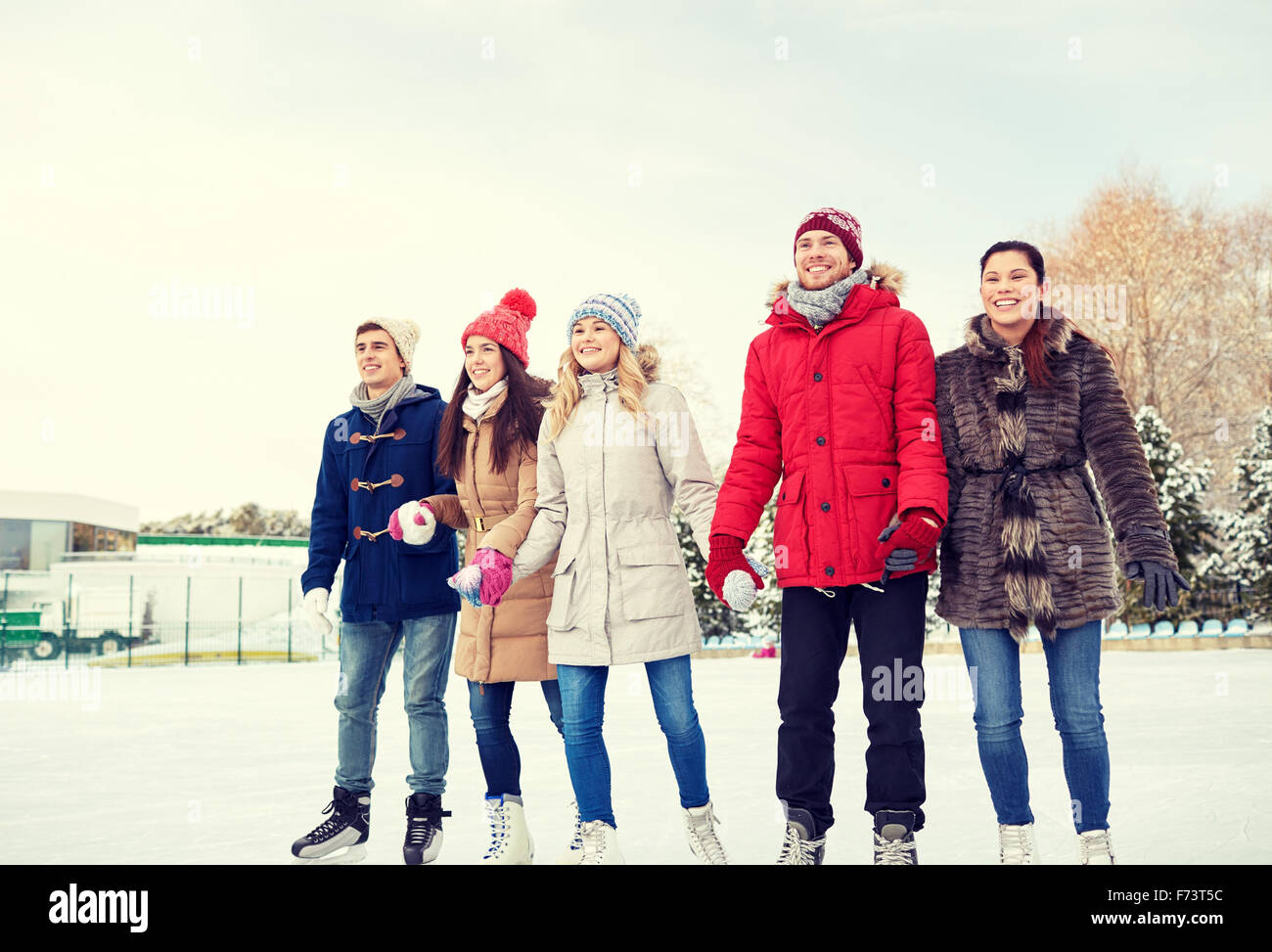happy friends ice skating on rink outdoors Stock Photo - Alamy
