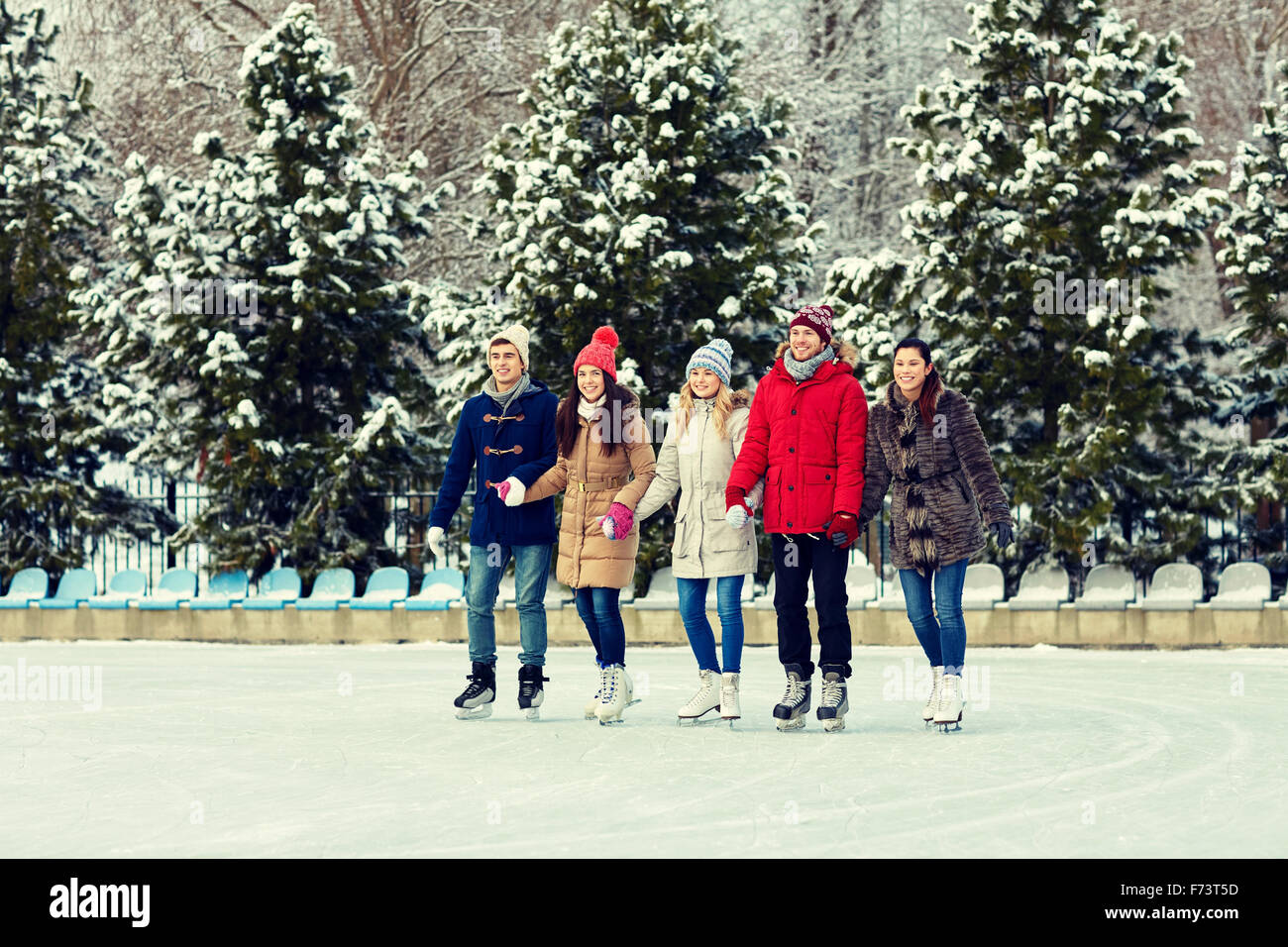 happy friends ice skating on rink outdoors Stock Photo - Alamy