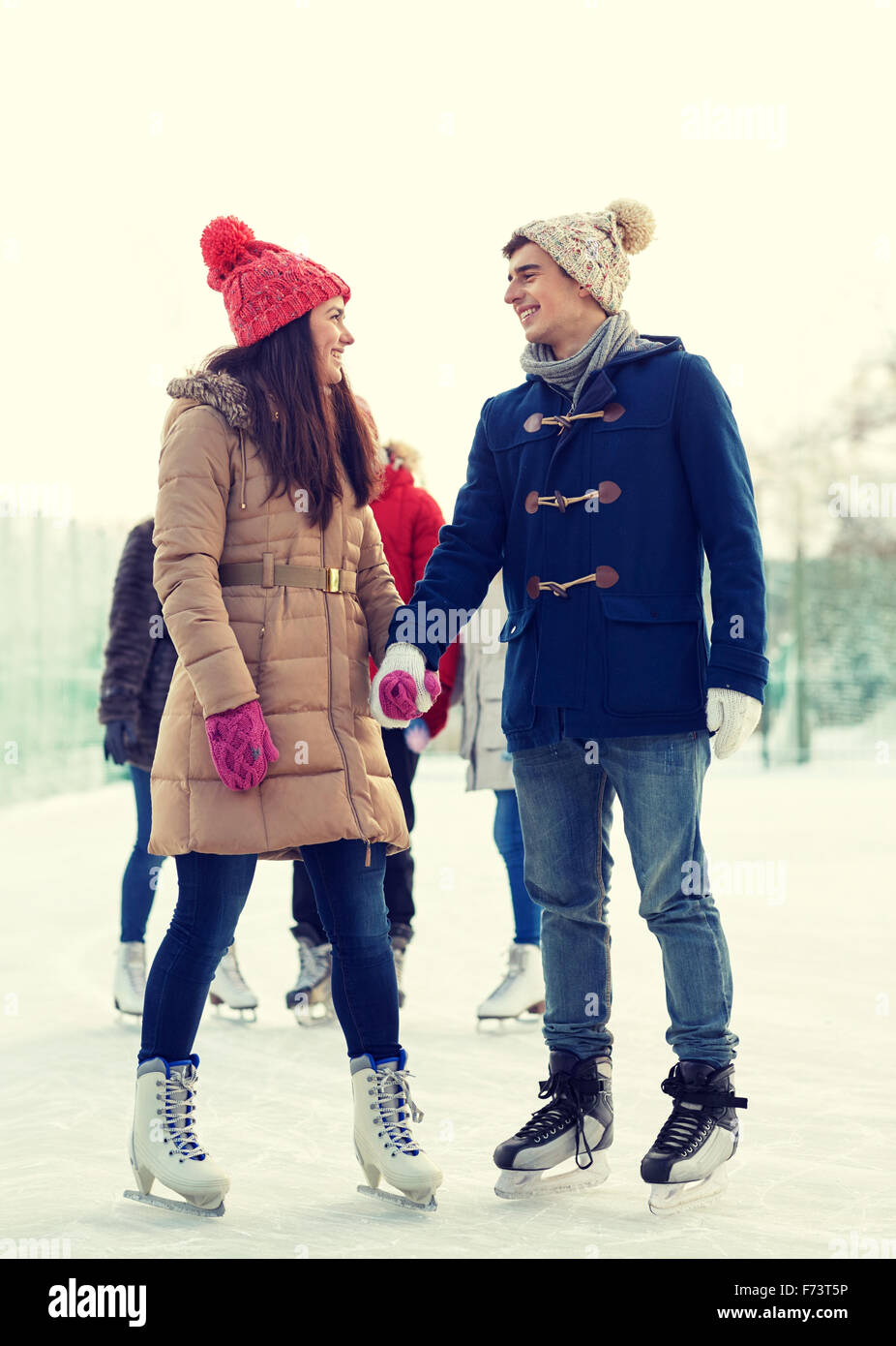happy friends ice skating on rink outdoors Stock Photo - Alamy